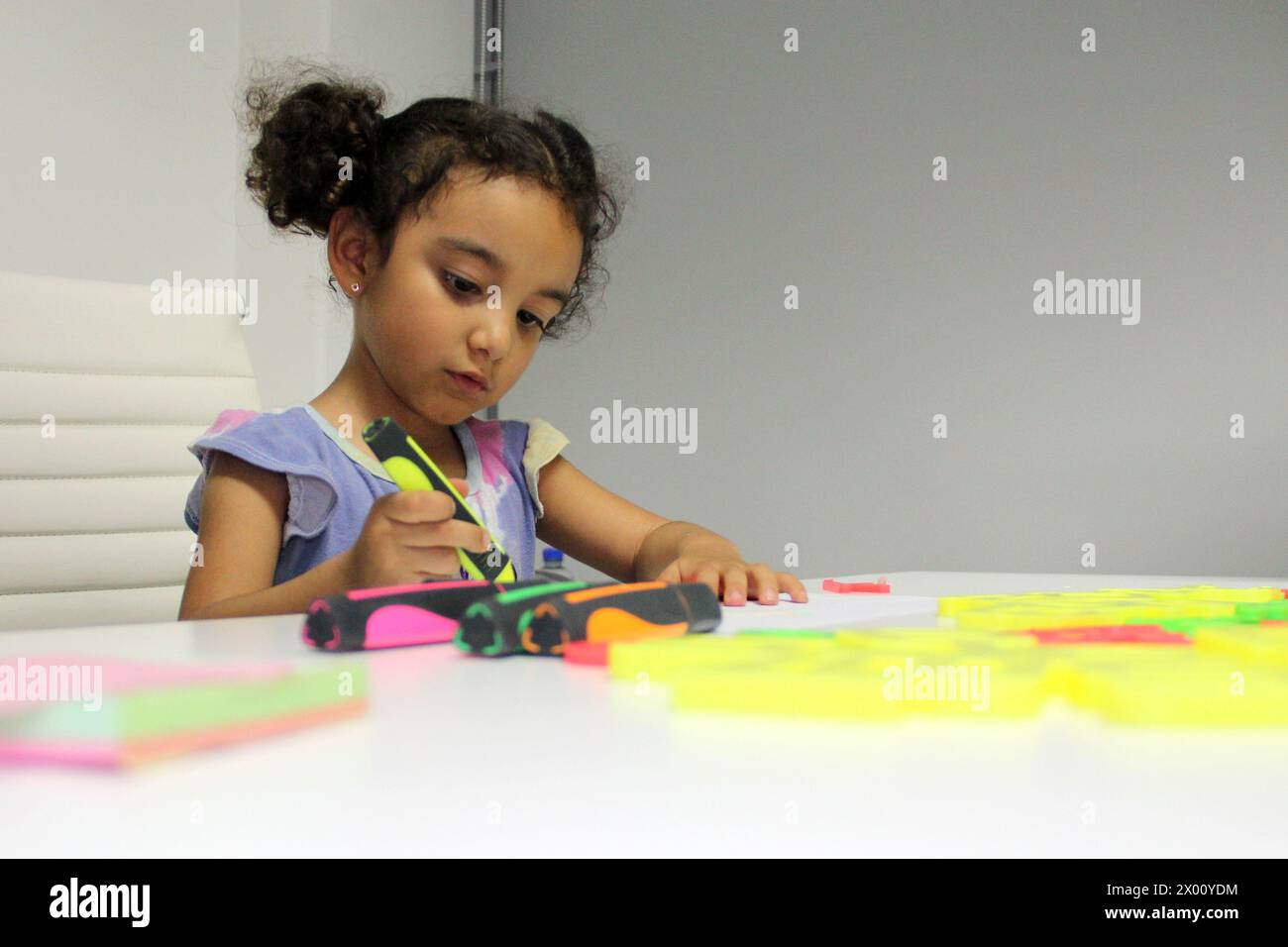 3 year old Latina brunette girl with curly hair draws as therapy for ...