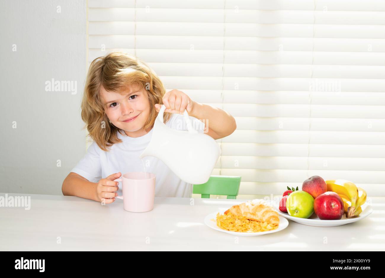 Fuuny little boy pouring whole cows milk for breakfast. Kid preteen boy ...