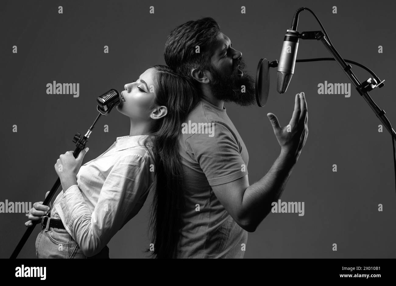 Guy and lady with excited faces enjoy music. Karaoke singer couple. Man ...