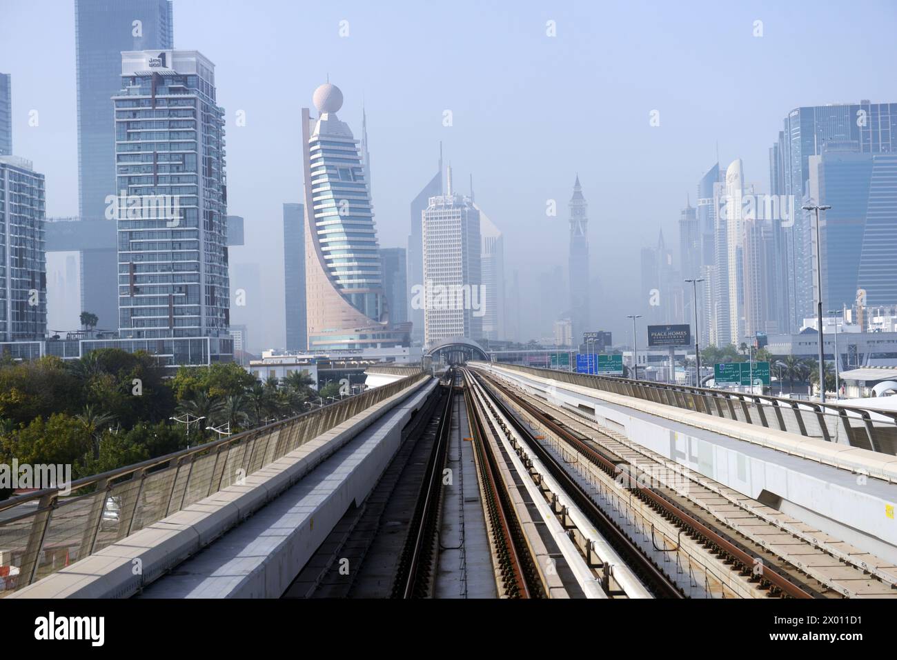 Dubai's modern skyline viewed from the elevated metro train. Dubai, UAE ...