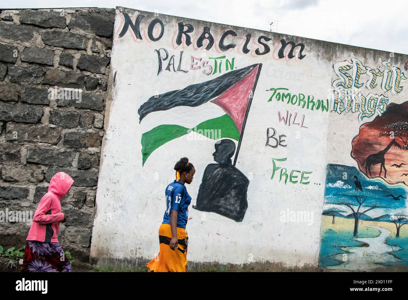 Nakuru, Kenya. 08th Apr, 2024. People walk past a mural featuring a ...