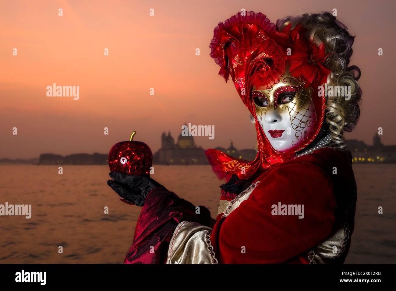 Portrait of a feminin masked person in a creative costume, posing on ...