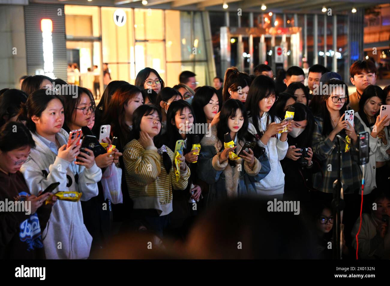 Changsha, China. 09th Apr, 2024. Citizens are watching a street performance at Desiqin City ...