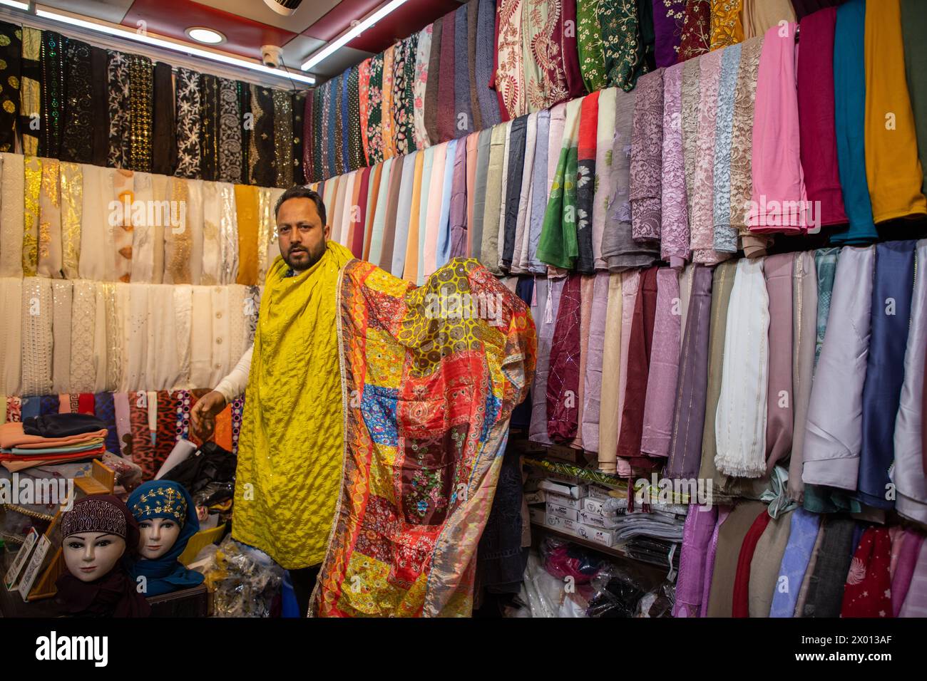 Srinagar, India. 08th Apr, 2024. Kashmiri Muslim shopkeeper attends to ...