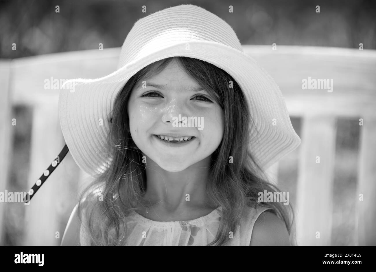 Portrait of pretty child girl in summer park. Face close up of cute ...