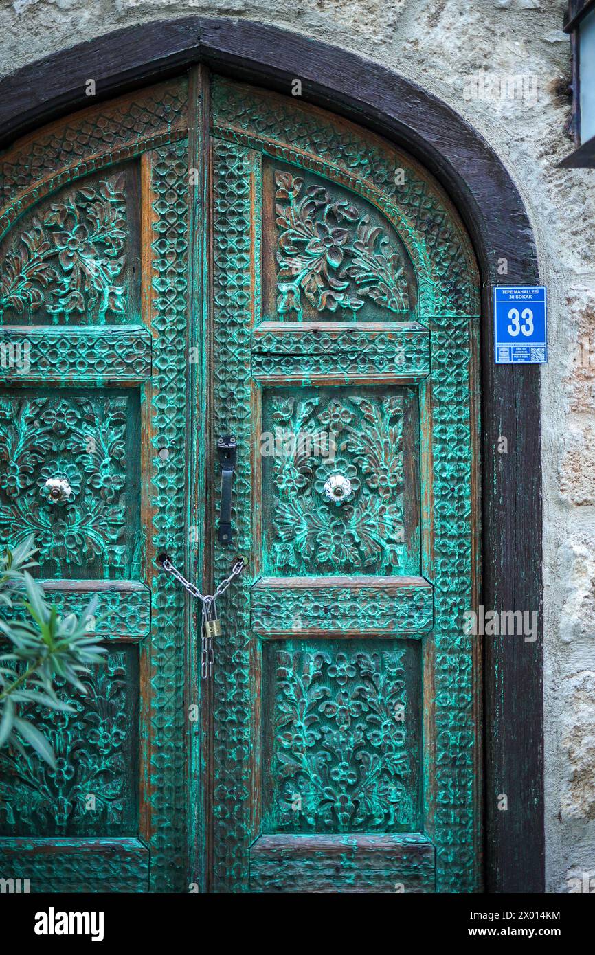 A bright emerald door with oriental patterns and a grey frame. Art ...