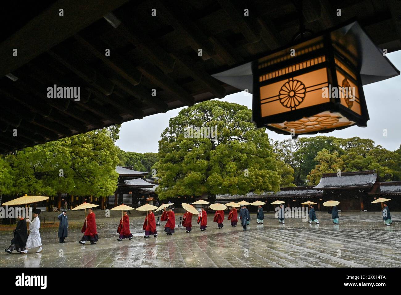 Shinto priests walk in procession on the grounds of Meiji Shrine before ...