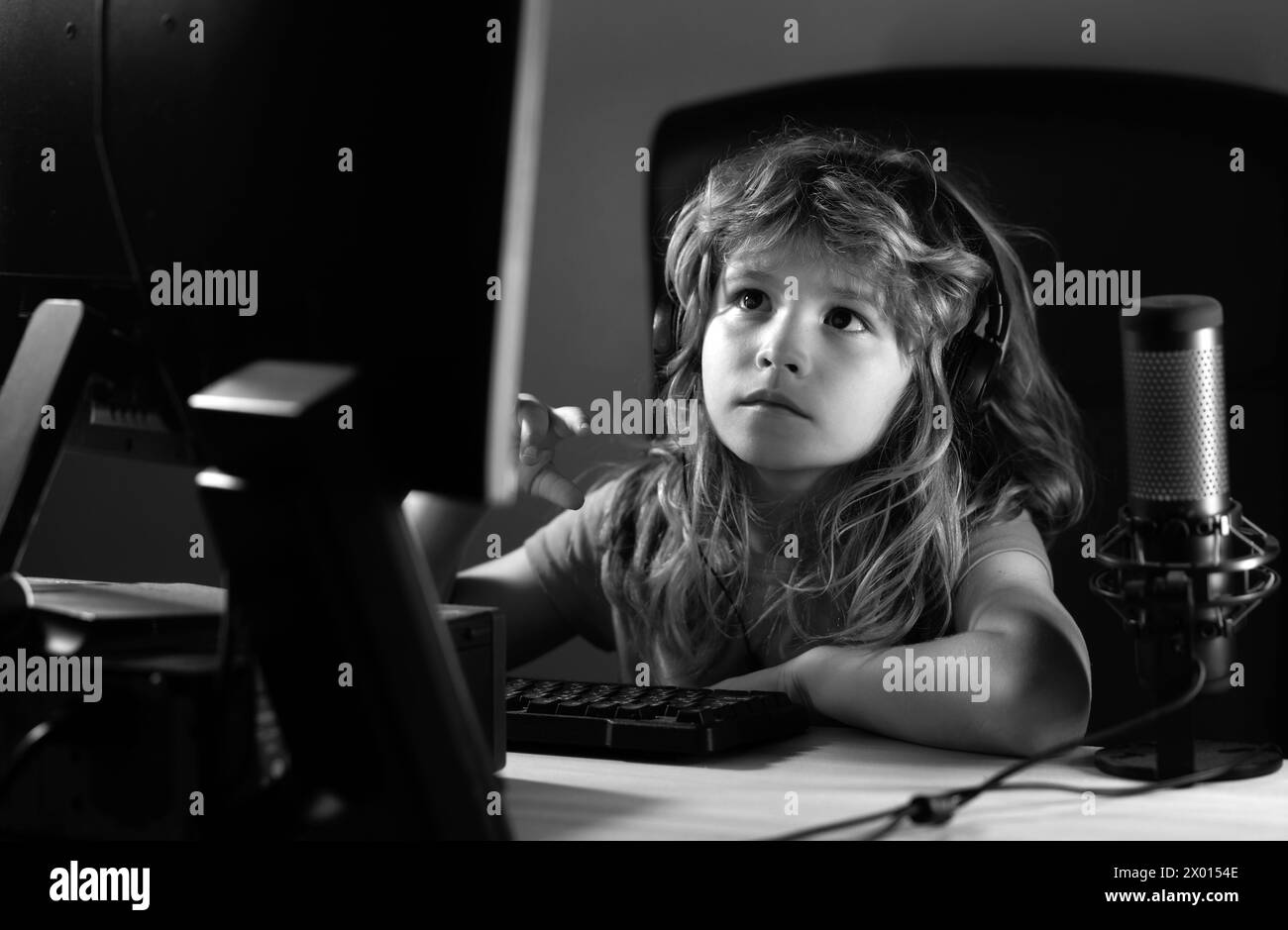Cute preschool child watching video lesson by laptop Stock Photo - Alamy