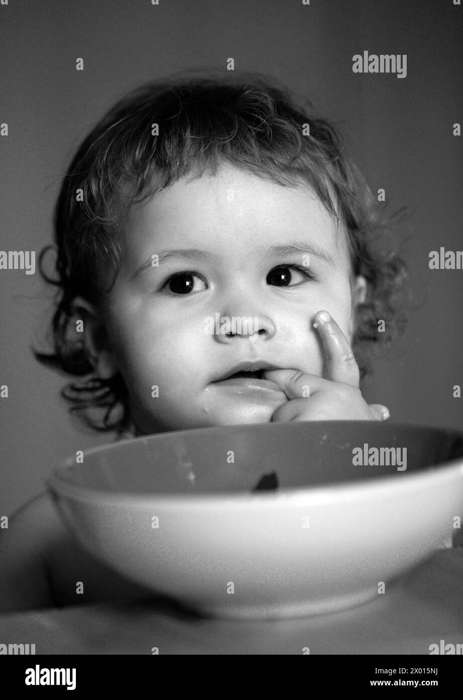 Happy child eating delicious dessert Black and White Stock Photos ...