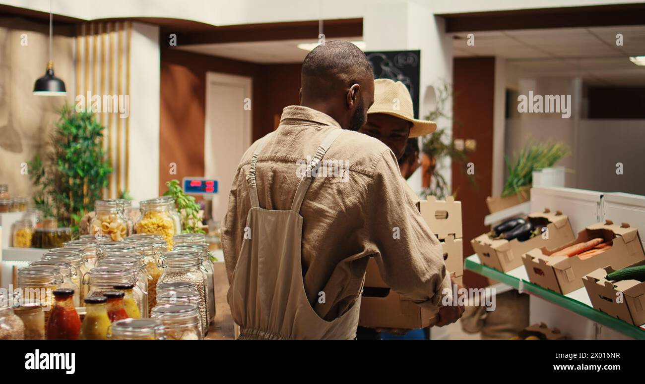 Small business owner receiving new produce stock from contractor ...