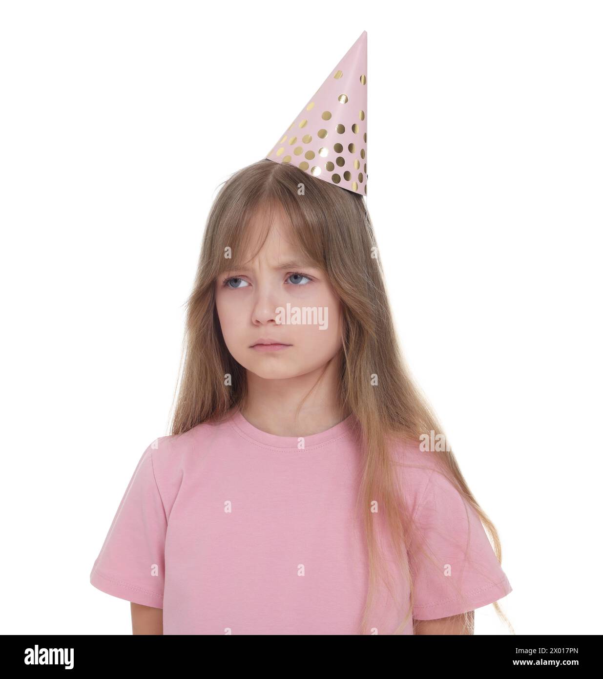 Unhappy little girl in party hat on white background Stock Photo - Alamy