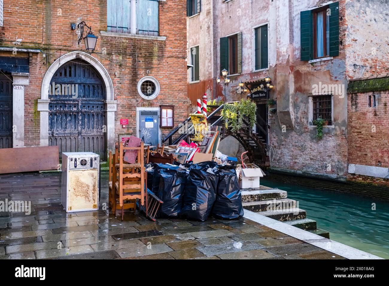 A pile of rubbish stacked on the edge of a canal in Venice Stock Photo ...