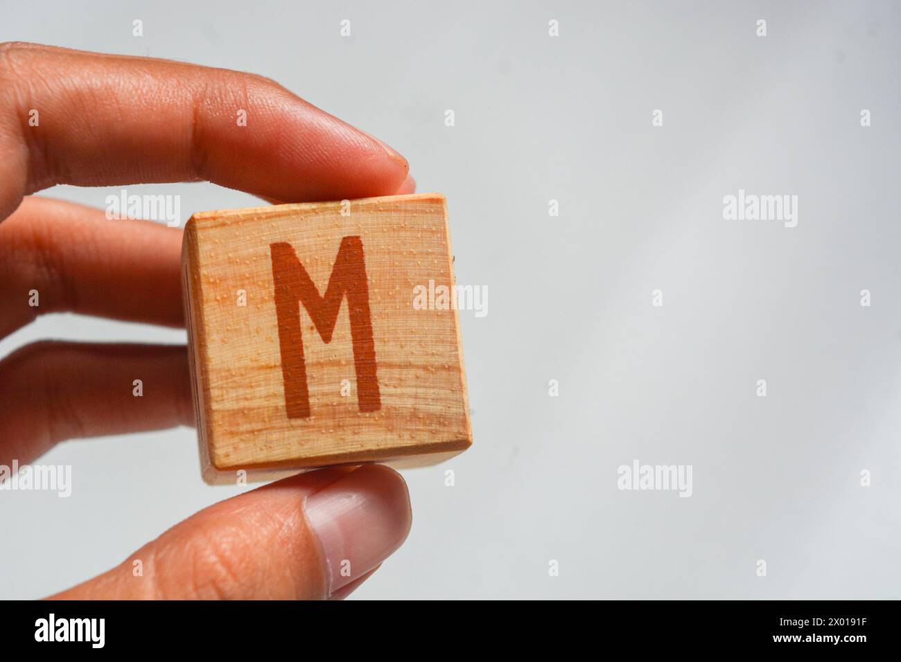 Letter M. Alphabet on wooden block. Isolated on a white background ...