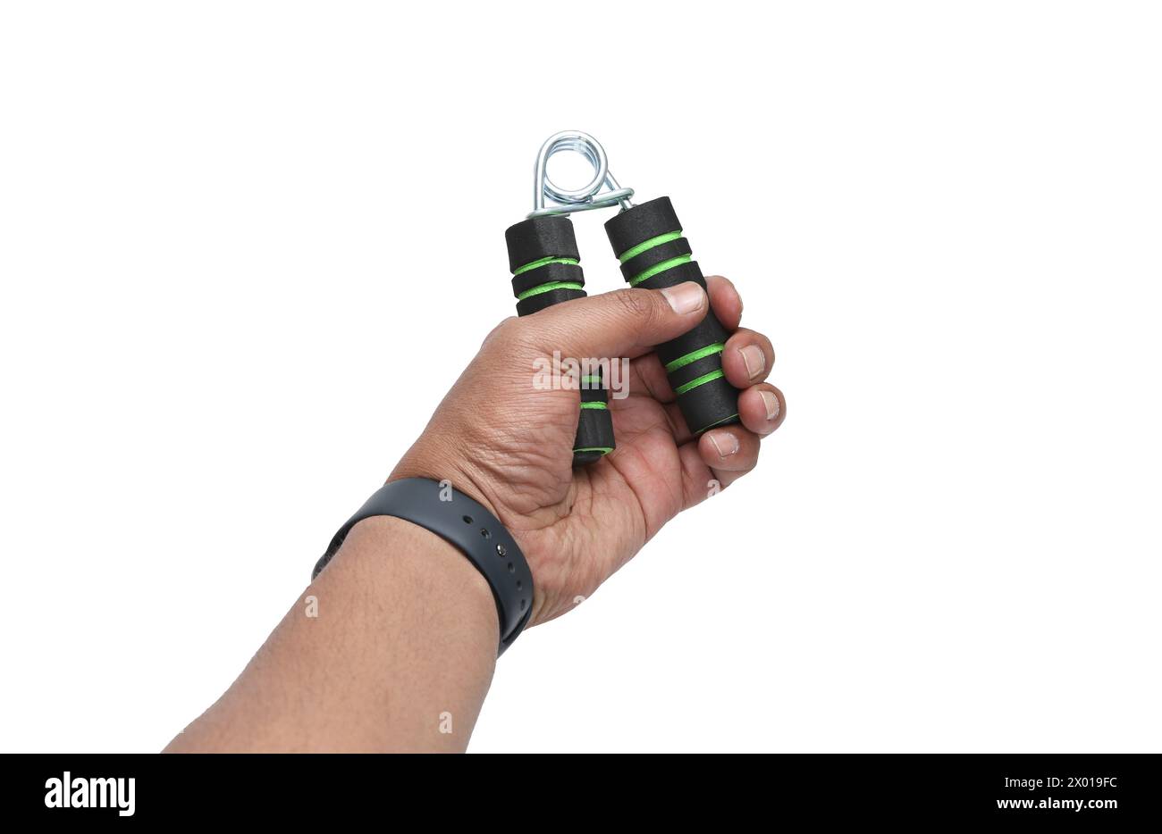 A hand is exercising by holding and squeezing a hand gripper on white ...