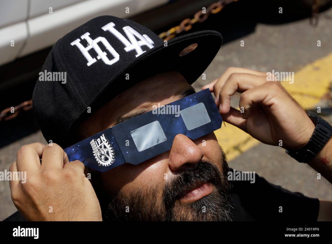 Non Exclusive: A man observes the solar eclipse through a special ...