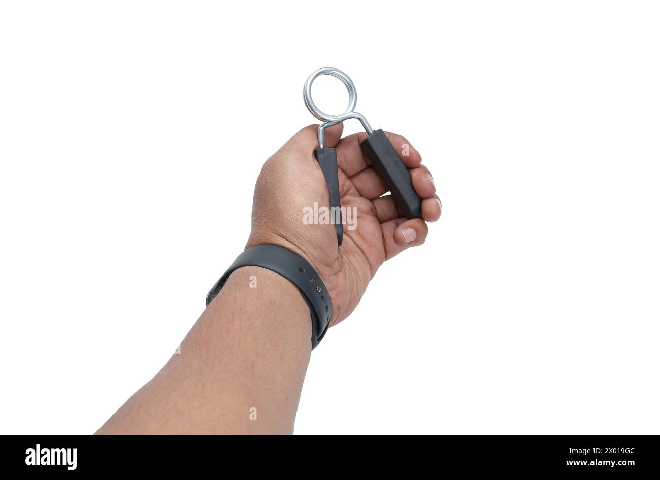 A hand is exercising by holding and squeezing a hand gripper on white ...