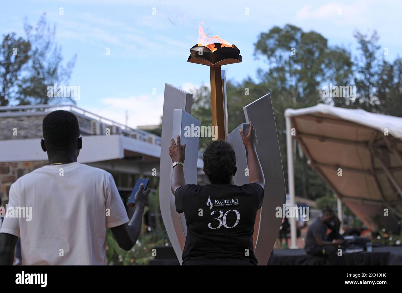 Kigali. 8th Apr, 2024. People look at the flame of remembrance at the ...