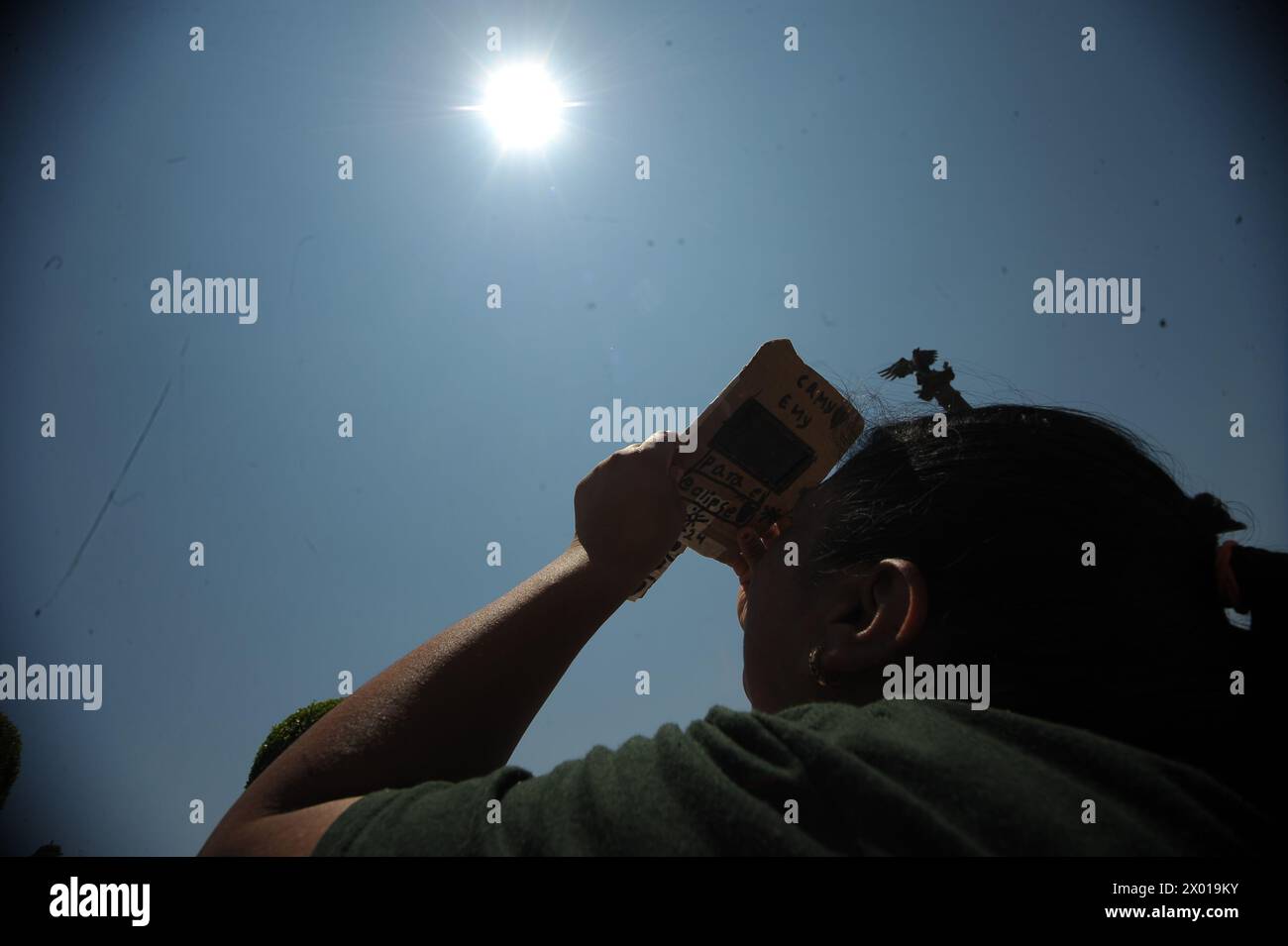 Non Exclusive: A woman watches the solar eclipse through a welder's ...