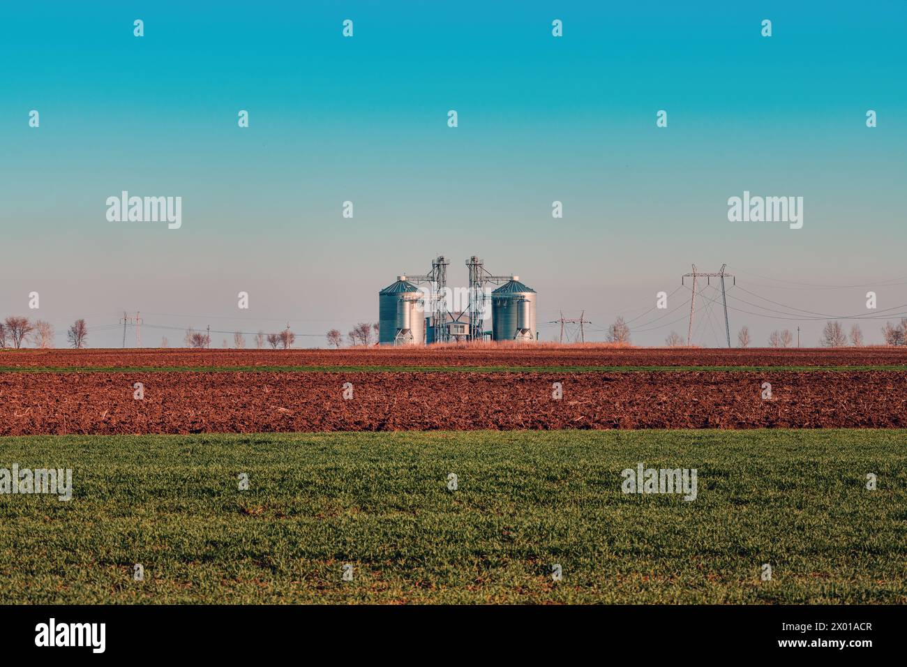Grain storage silos, large agricultural building on farmland, selective ...