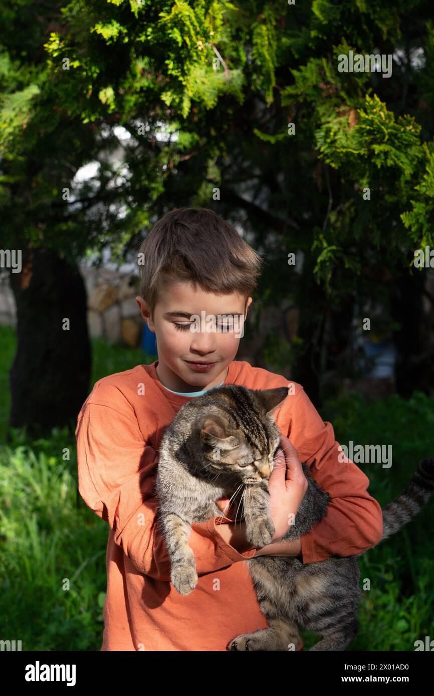 Boy holding his cat in his arms Stock Photo - Alamy