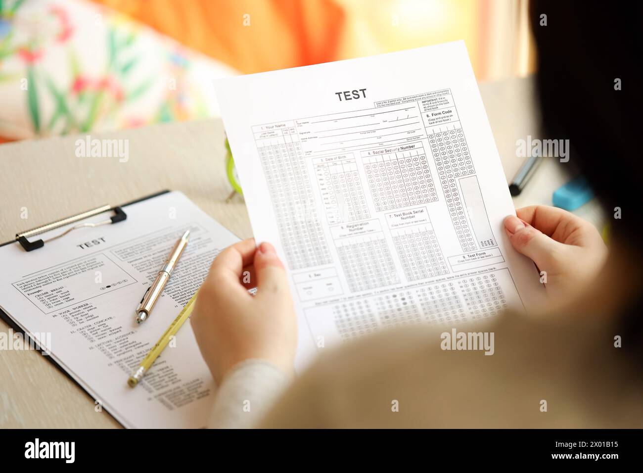 Female student hands testing in exercise and hold exam paper sheet with ...