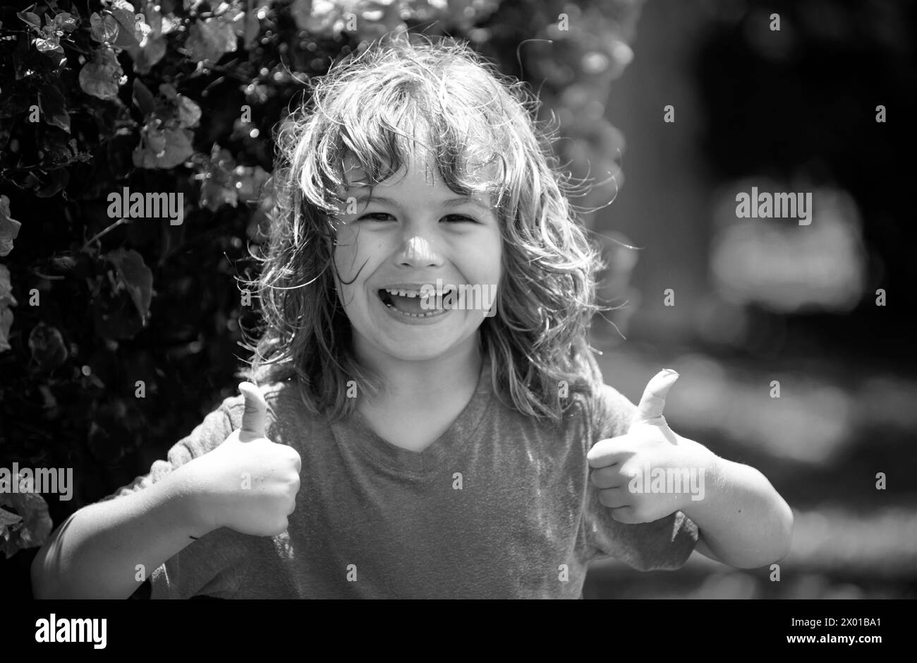 Portrait of a happy laughing child. Close up positive kids face, thumbs ...