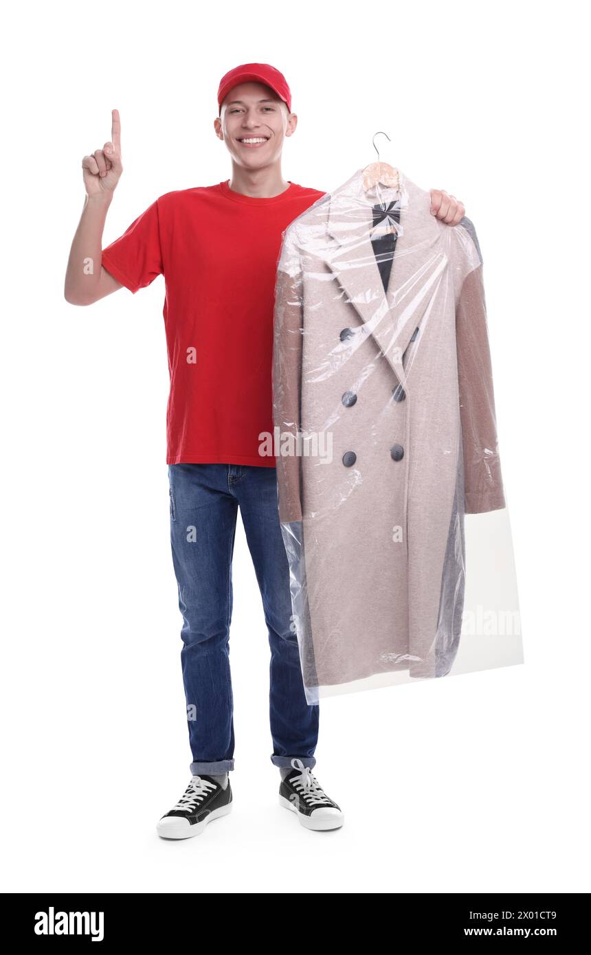 Dry-cleaning delivery. Happy courier holding coat in plastic bag and ...