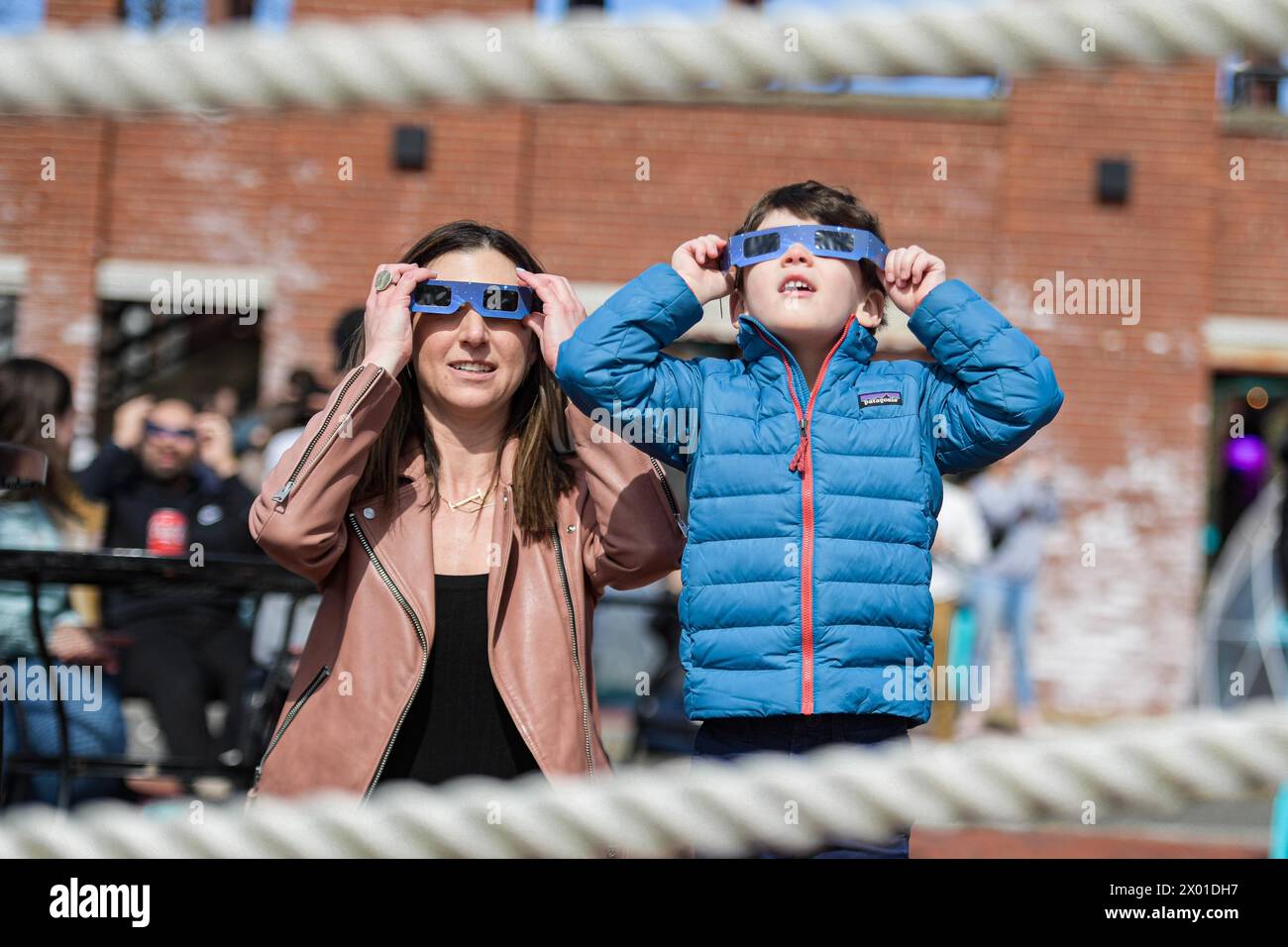 Boston, USA. 8th Apr, 2024. People watch a solar eclipse in Boston, the ...