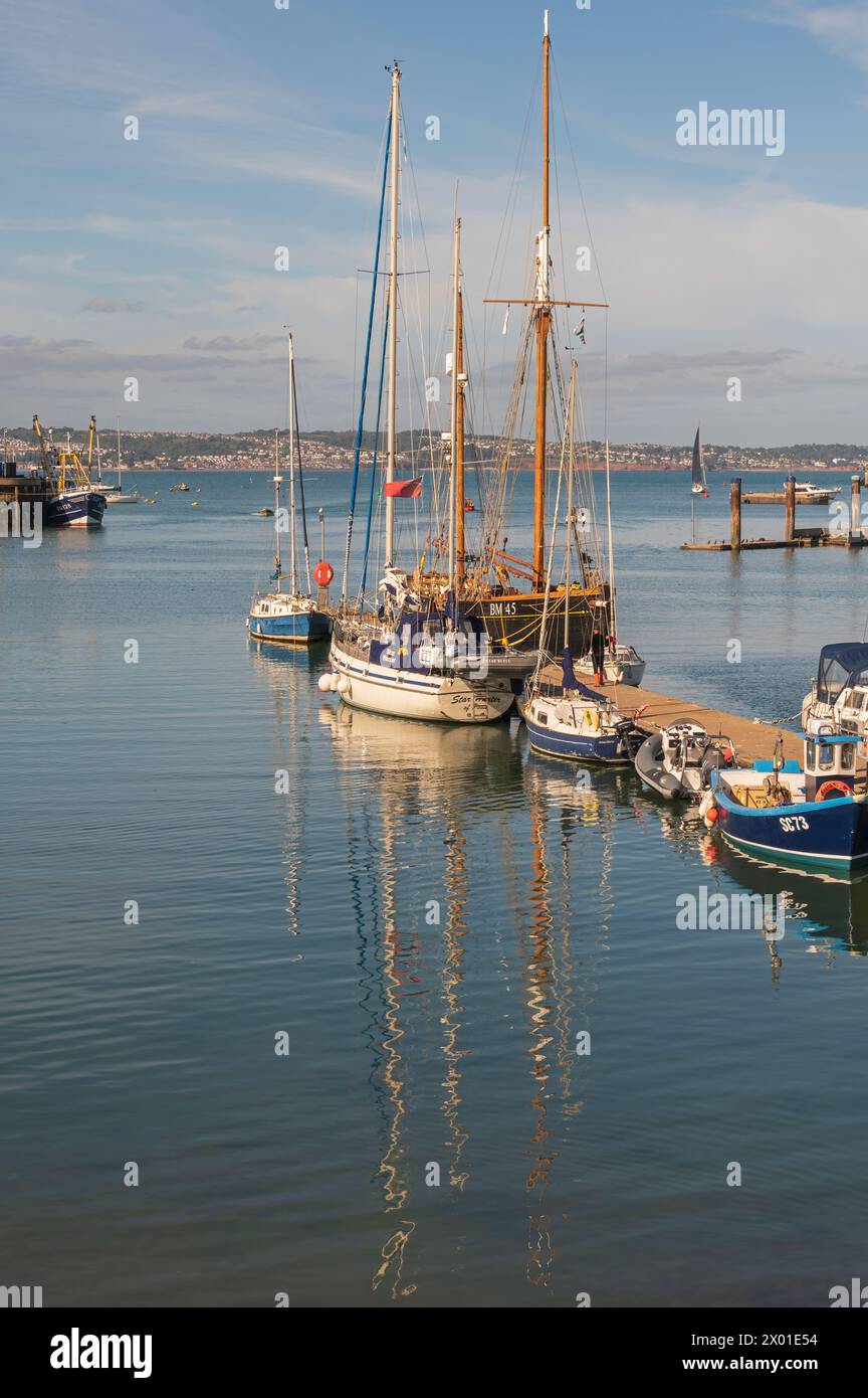 Pleasure craft moored along a floating jetty in the calm waters of the ...