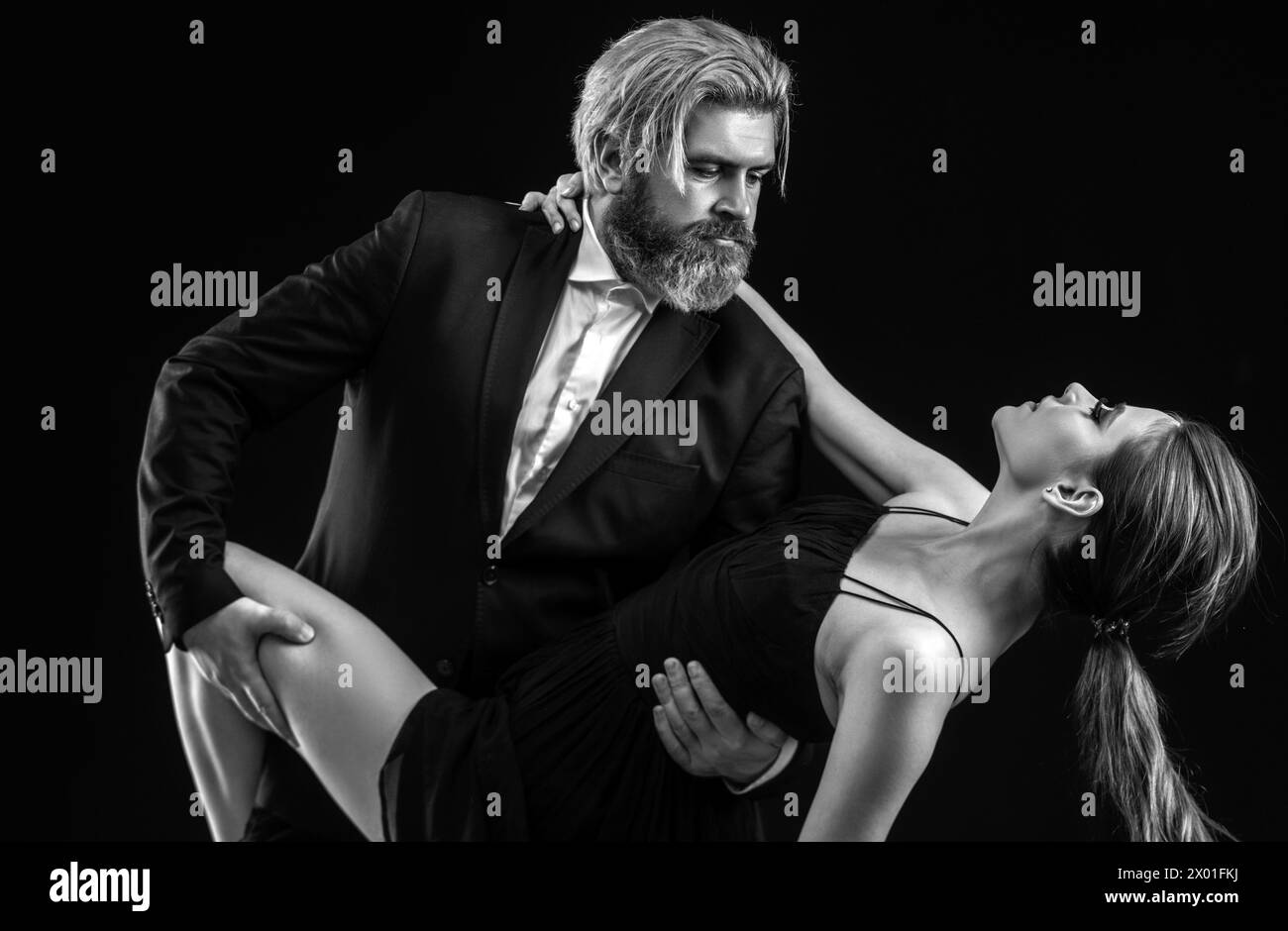 Salsa dancing couple. Young luxury pair dance isolated on black ...