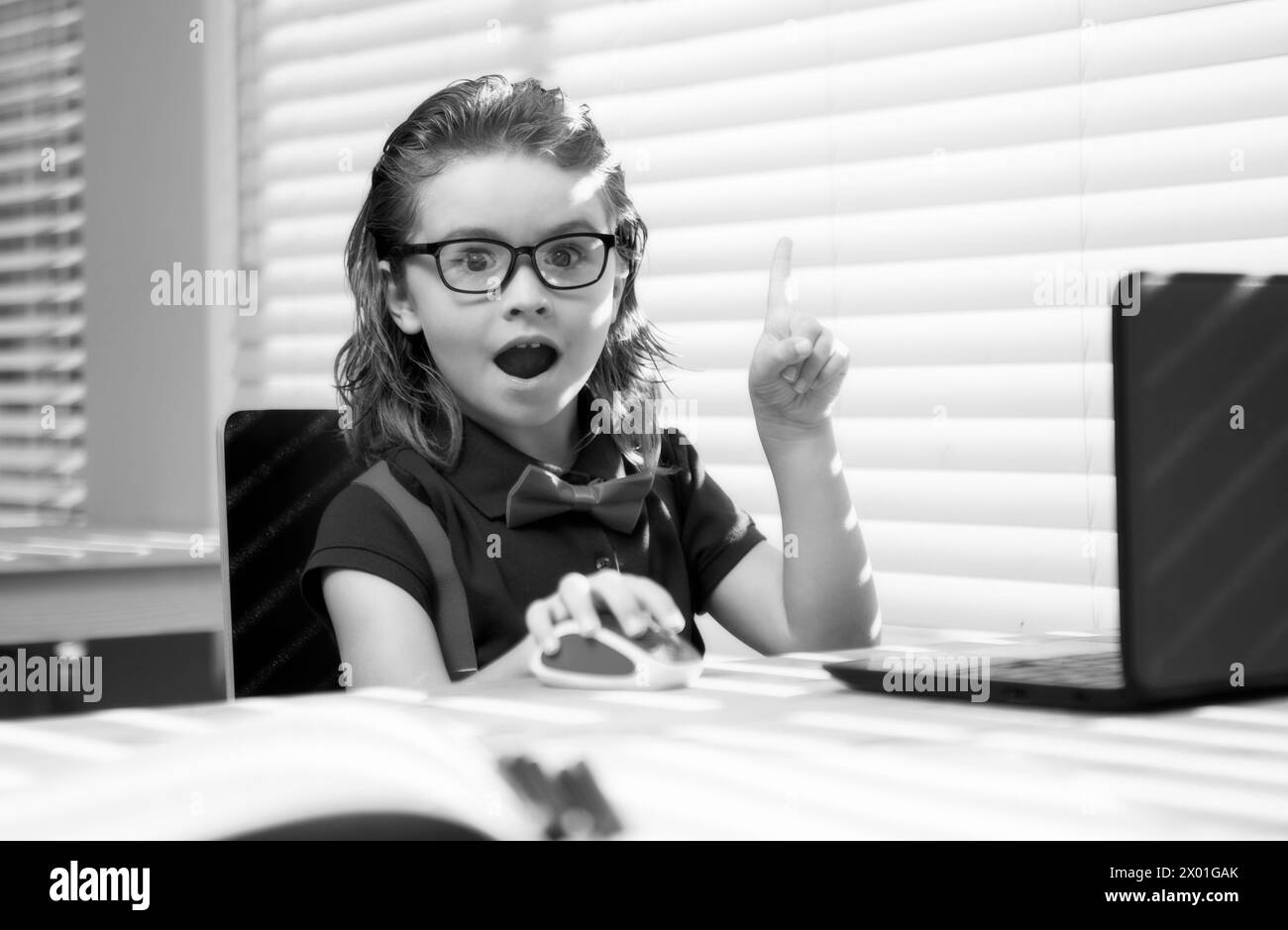 Smart school boy at home writing homework. Little student with notebook ...