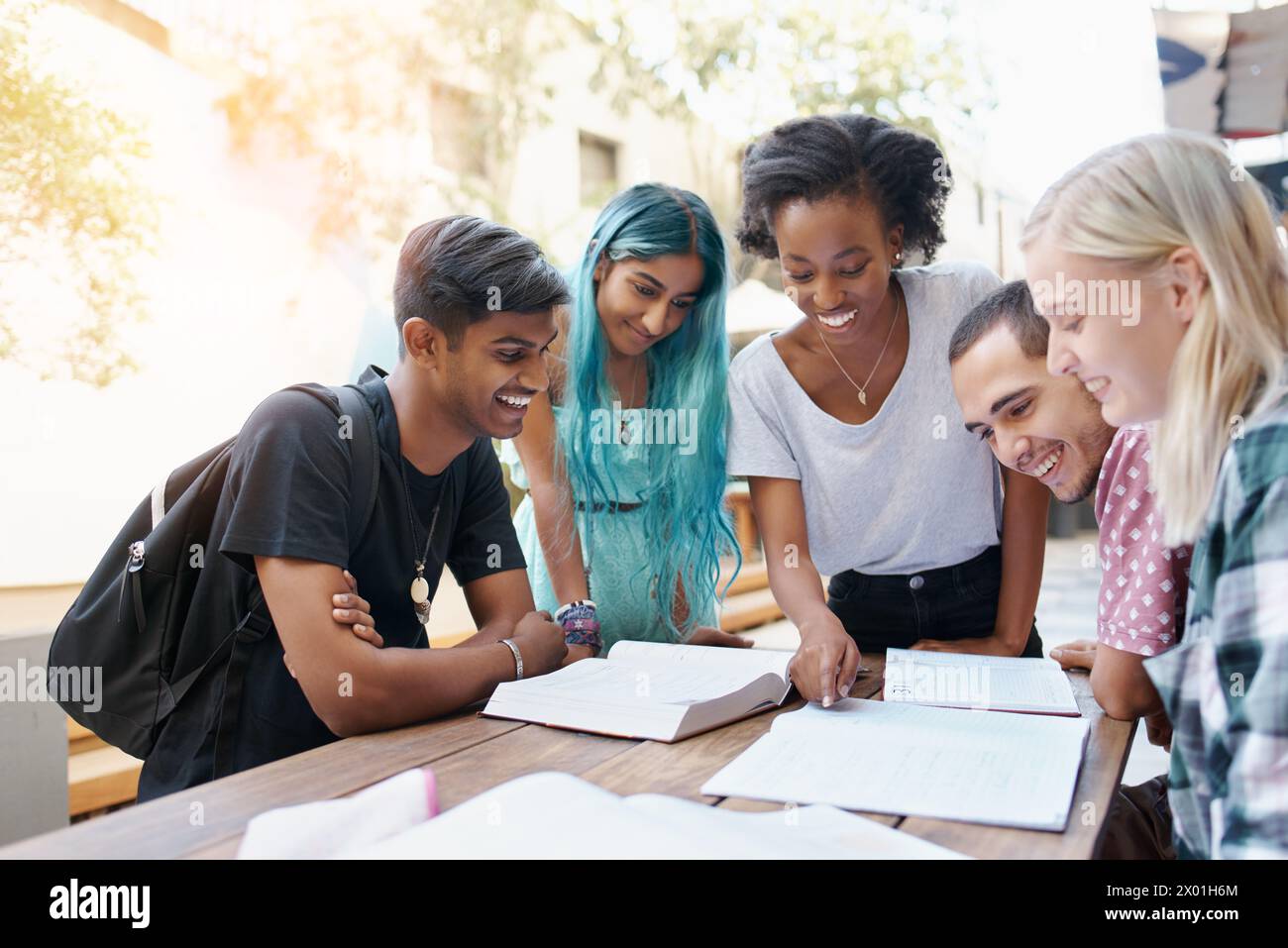 Friends, group and study outdoor at university with books, pointing and ...