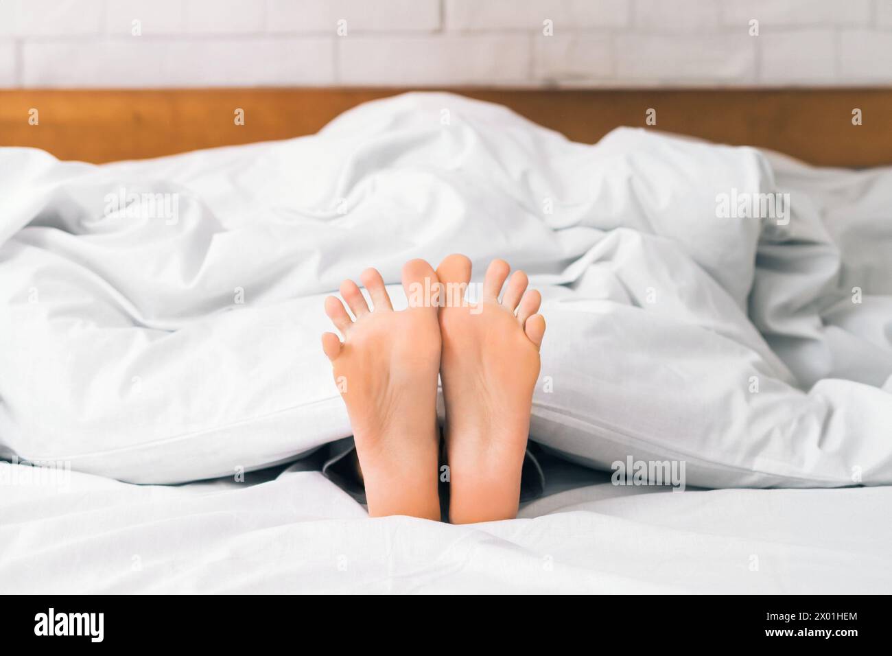 Woman stretching happily in bed after waking up Stock Photo - Alamy