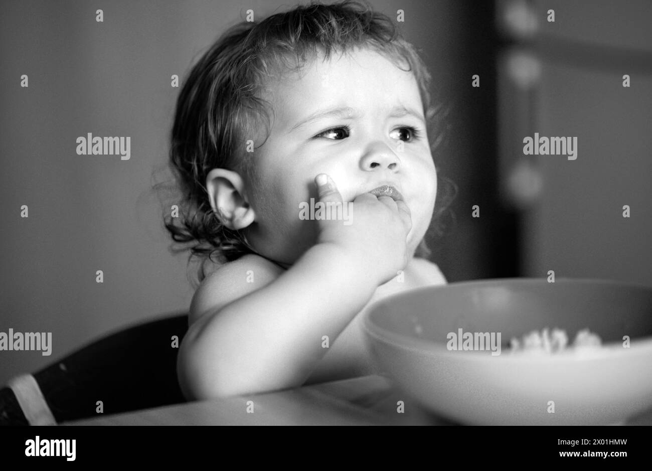 Portrait of cute Caucasian child kid with spoon. Hungry messy baby with ...