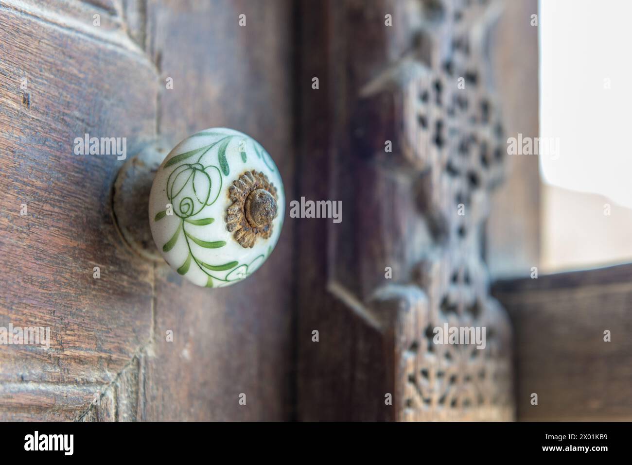 Narrow-focus detail of a painted, ceramic window shutter handle of a ...