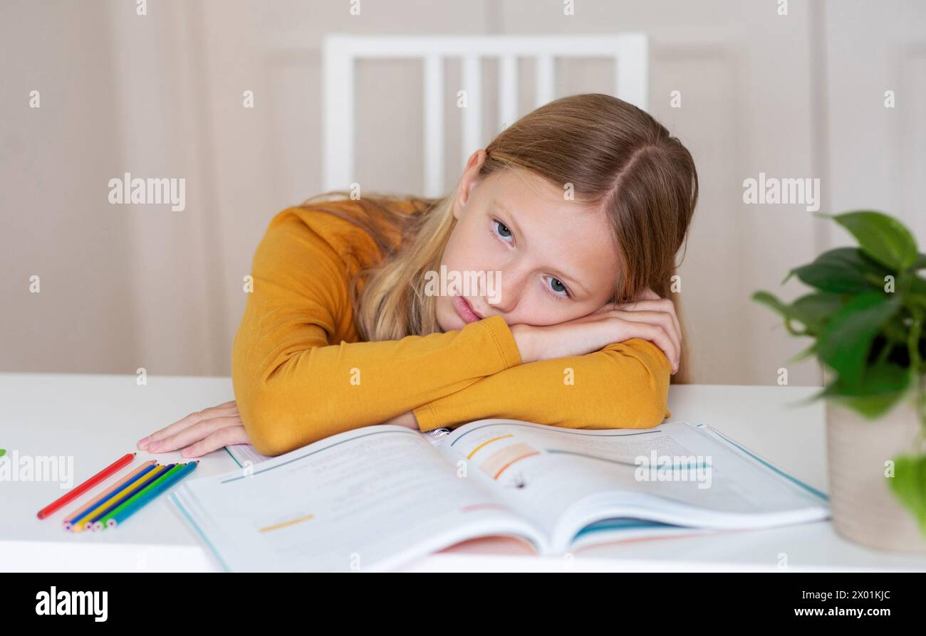 Teen girl student bored table reading hi-res stock photography and ...