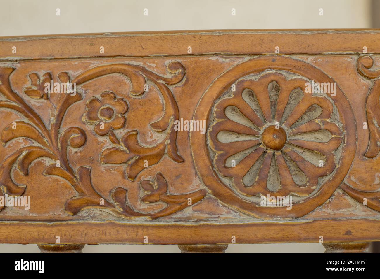 Detail of a carved wooden bench outside a restored traditional arabian ...
