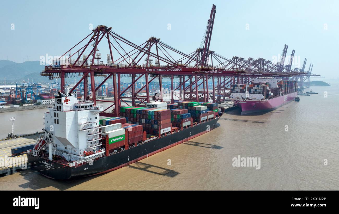 ZHOUSHAN, CHINA - APRIL 9, 2024 - Ships carry out container loading and ...