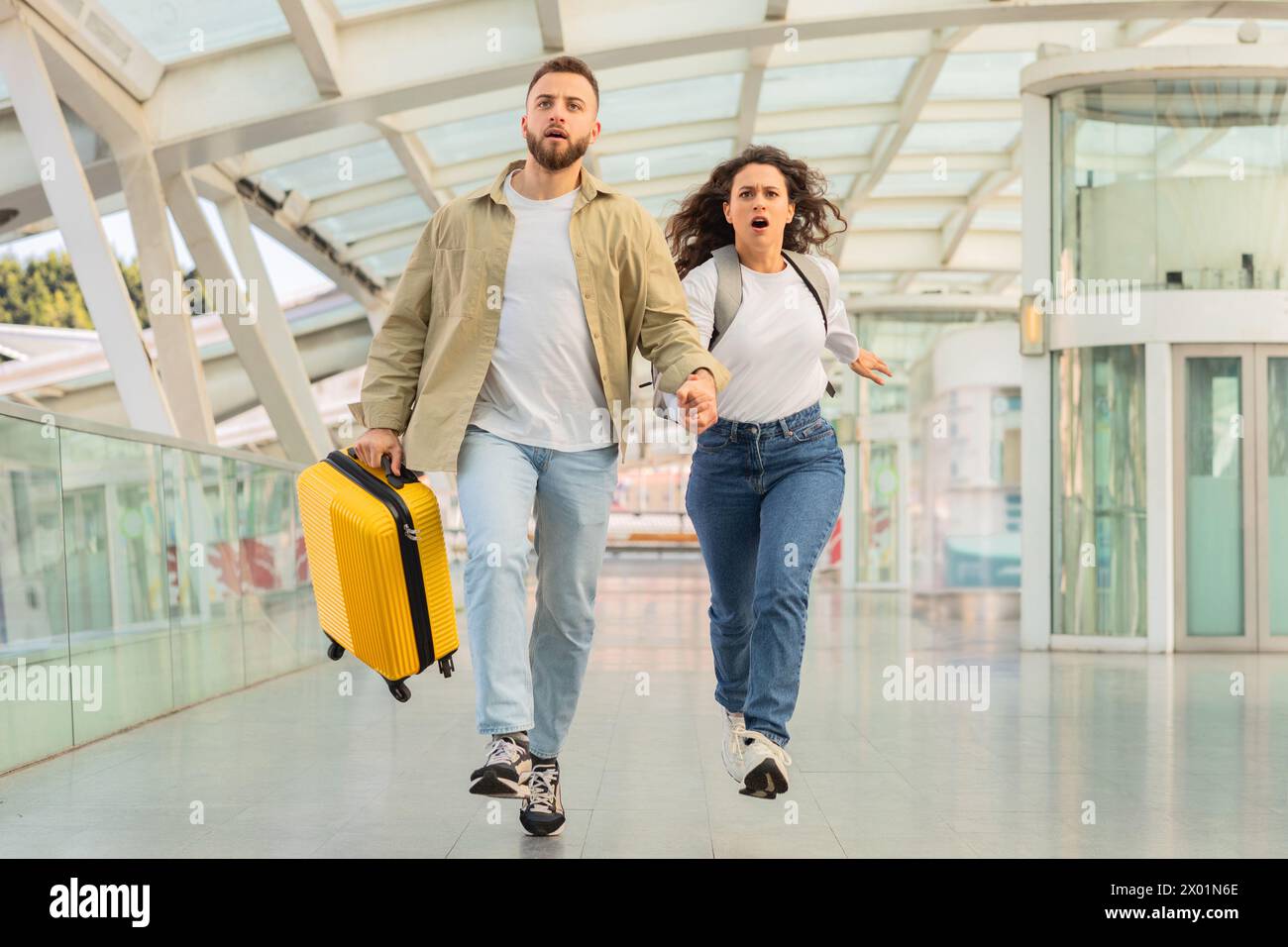 Urgent Dash Through Airport Terminal by Young Couple Stock Photo - Alamy