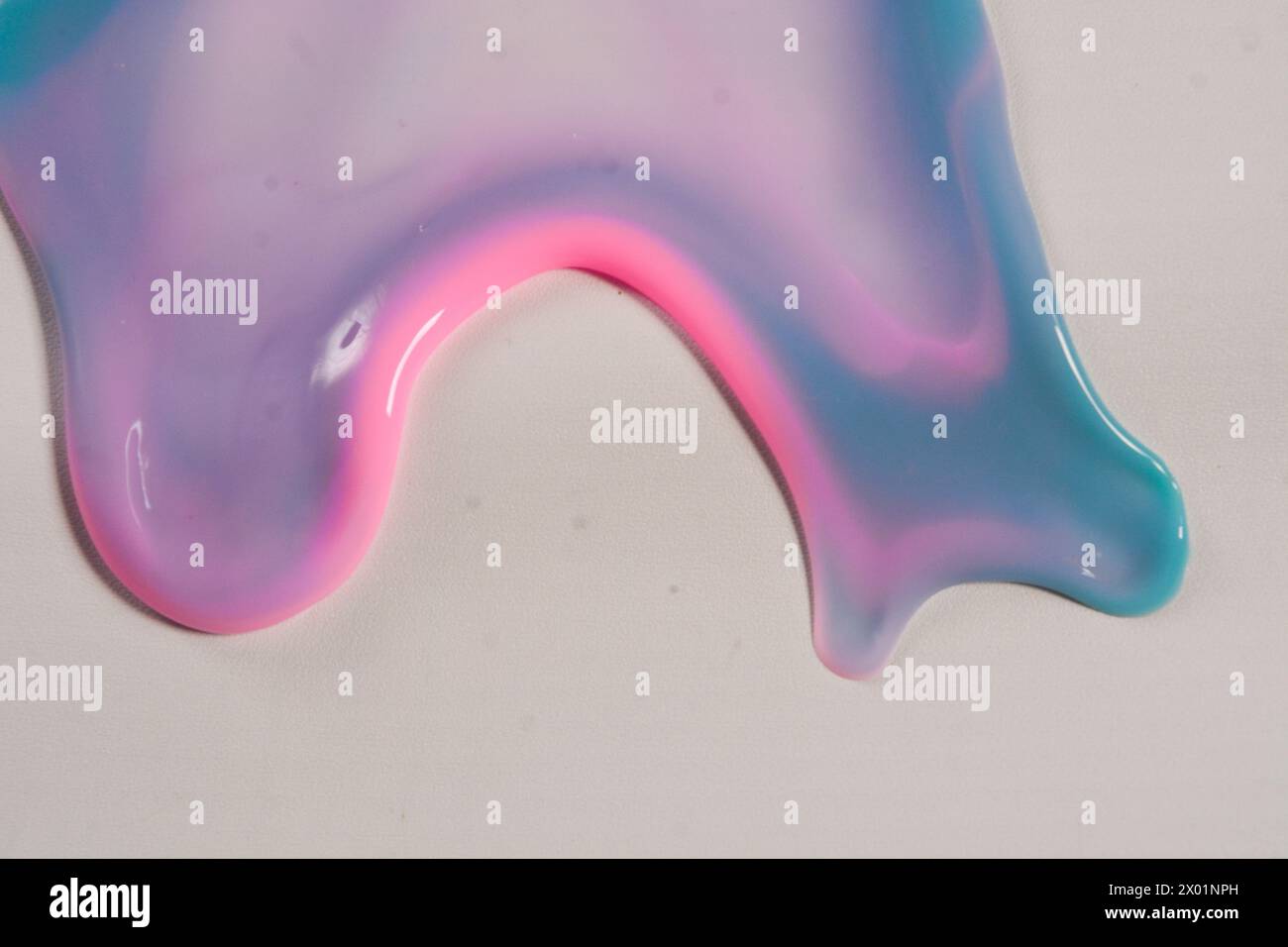 Colorful leaking paint liquid spills from close range Stock Photo - Alamy