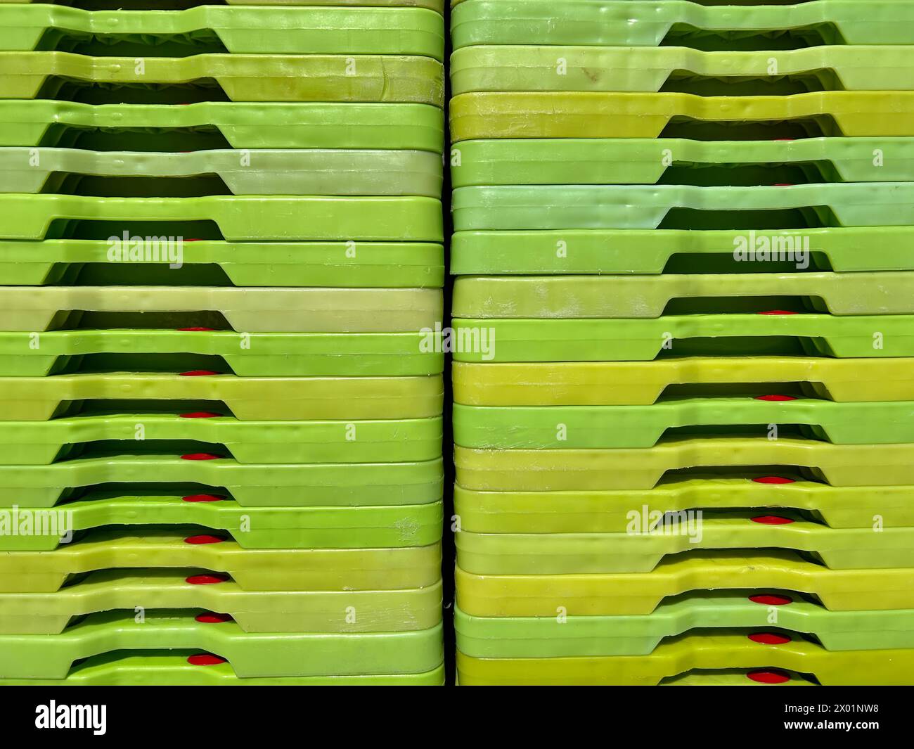 Green plastic boxes for industrial use, folded and stacked to form a ...