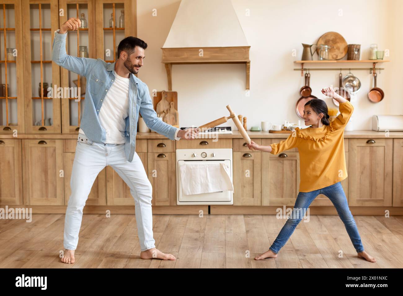 Father and daughter engaging in sword play Stock Photo - Alamy