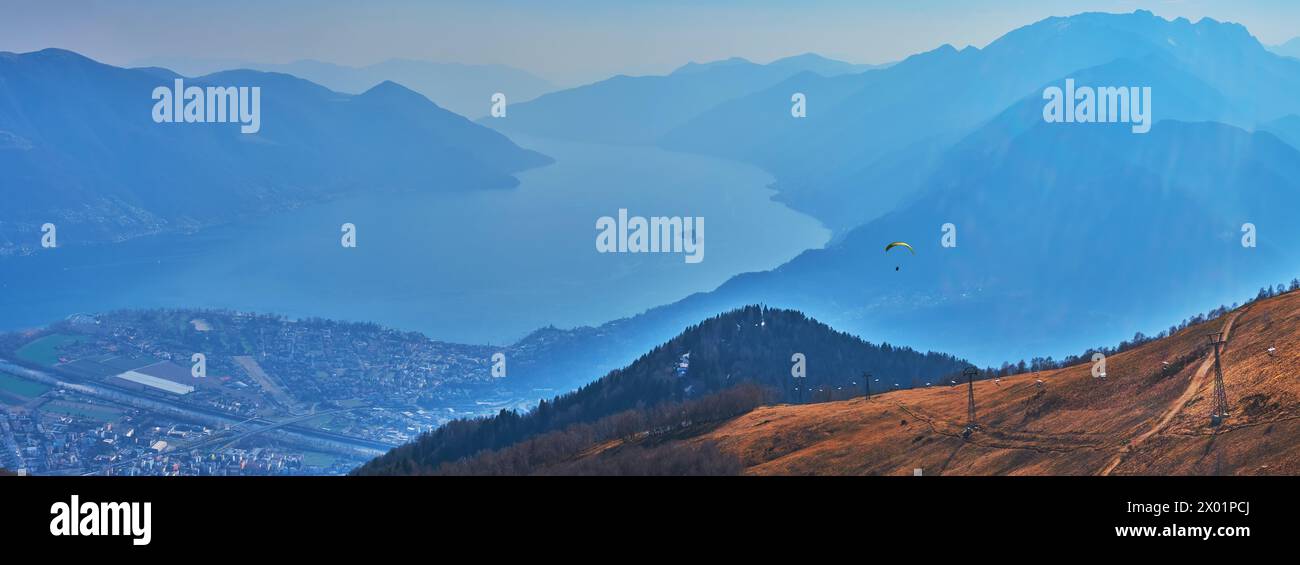 Hazy mountain scenery and the glider aircraft from the top of Cimetta ...