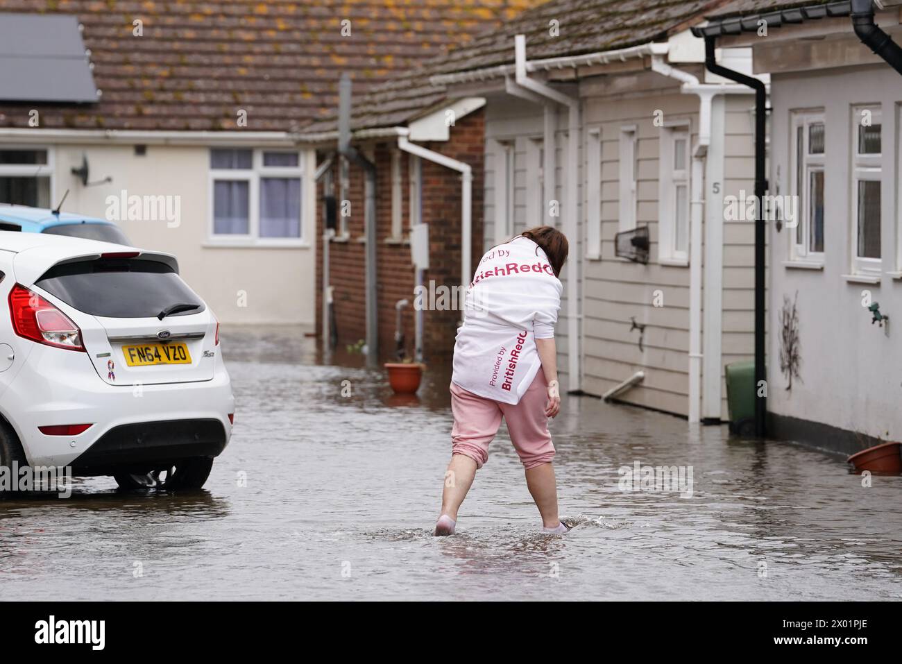 A resident wades through flood water in Rope Walk in Littlehampton ...