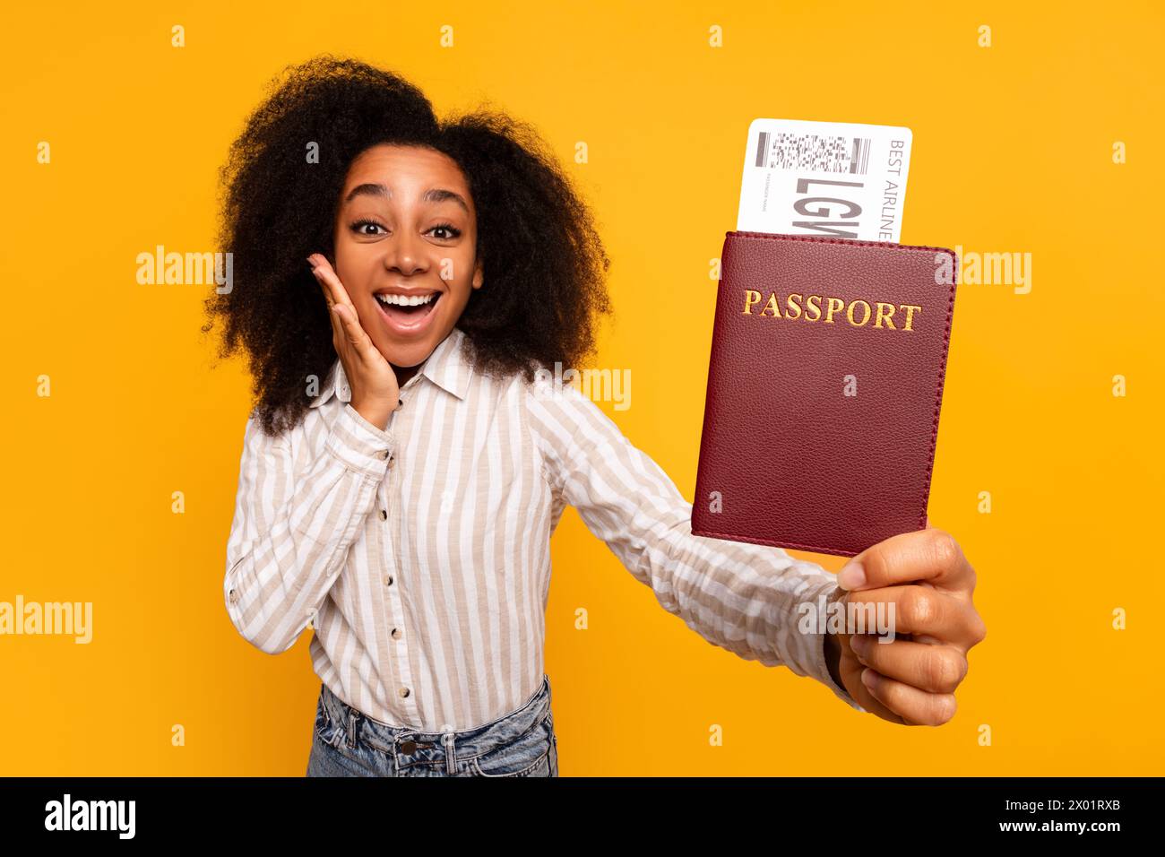 Excited lady traveler showing passport and ticket Stock Photo - Alamy