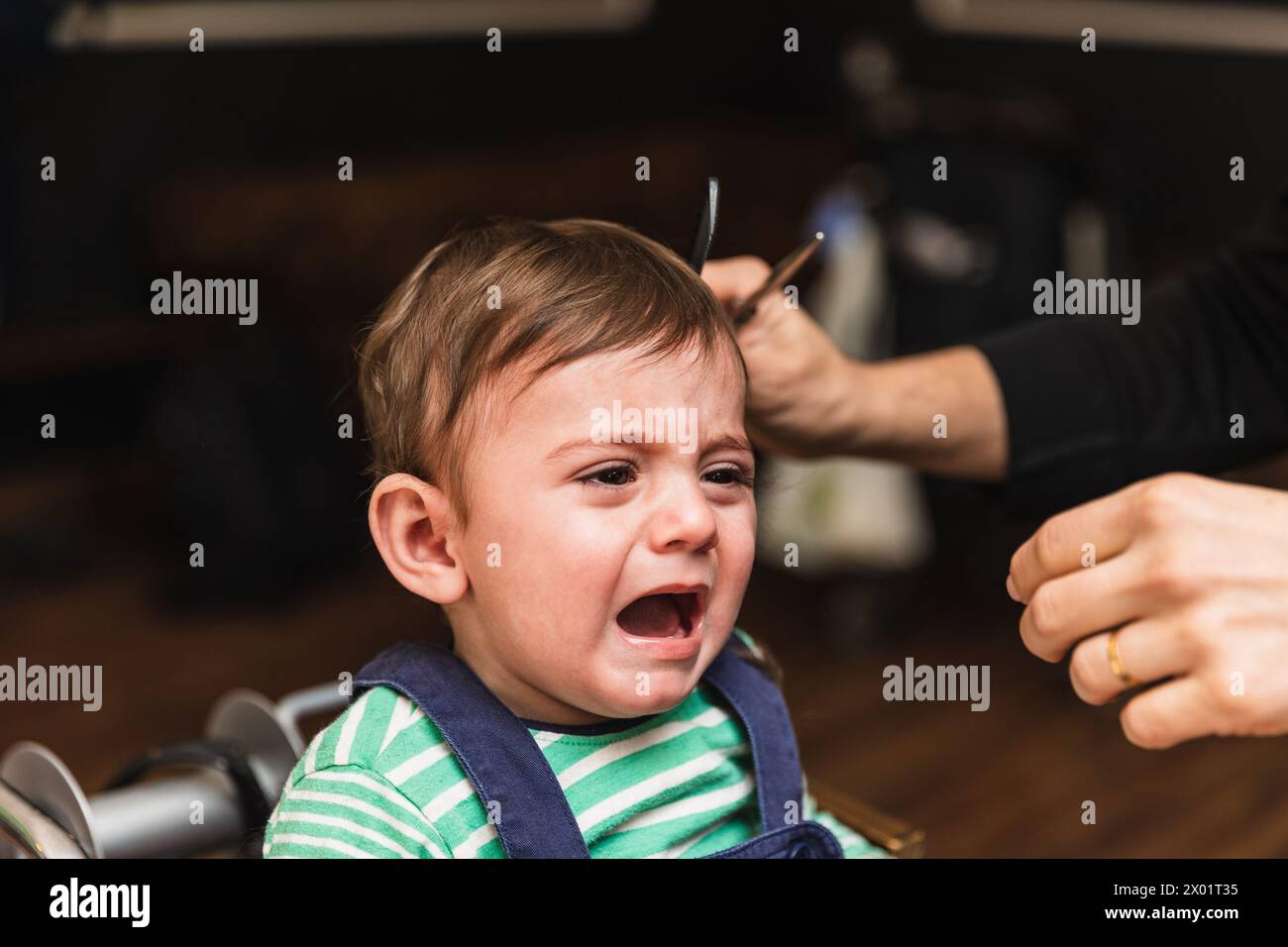 Toddler's first haircut: a challenging experience Stock Photo - Alamy