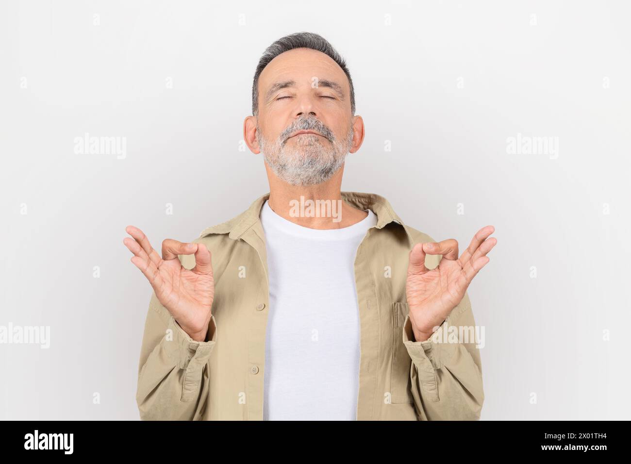 Senior man in zen pose with eyes closed Stock Photo - Alamy