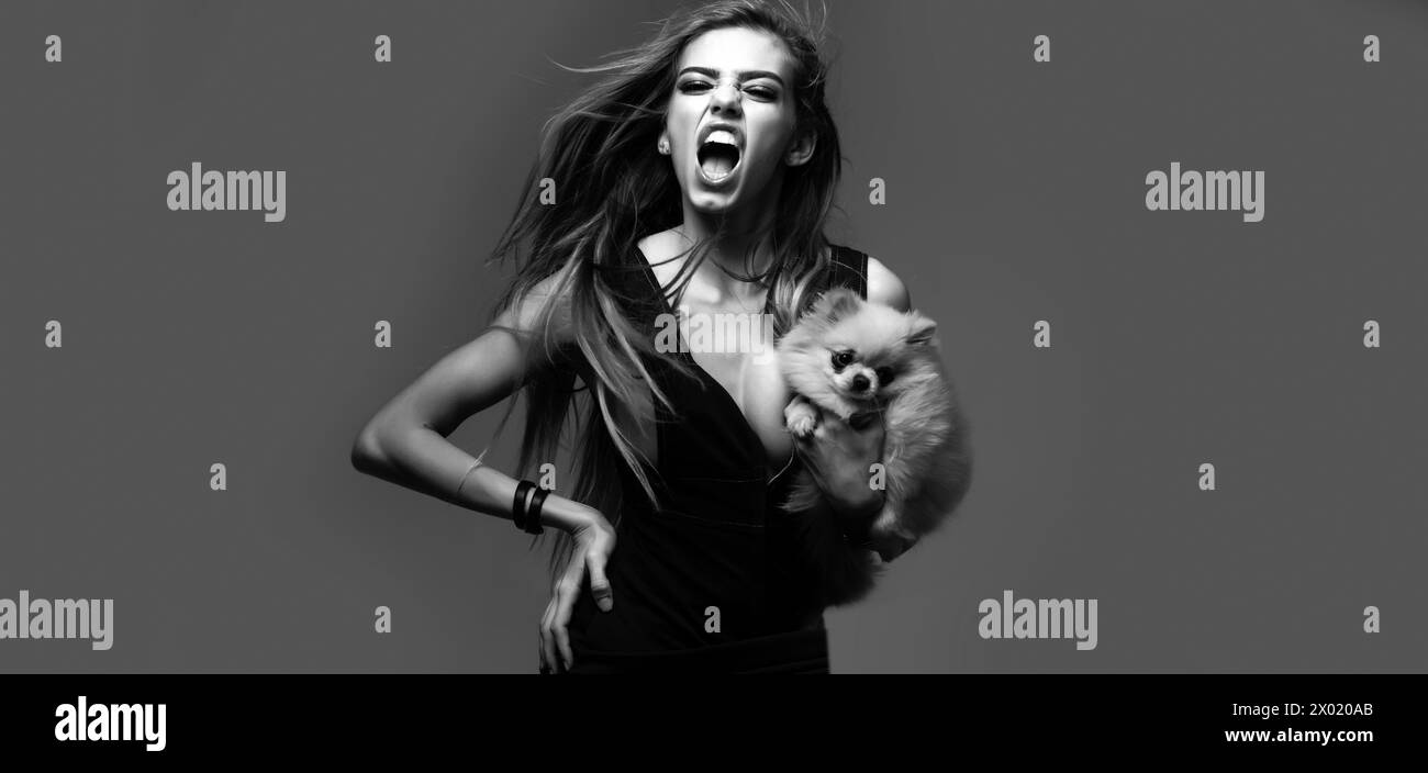 Young woman with pet dog screaming and shouting. Human emotions, facial ...