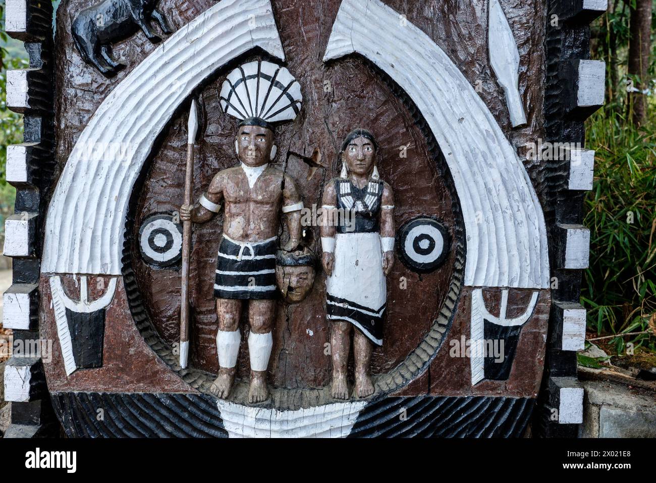 Traditional decorative carvings depicting headhunting in Kigwema a Naga ...