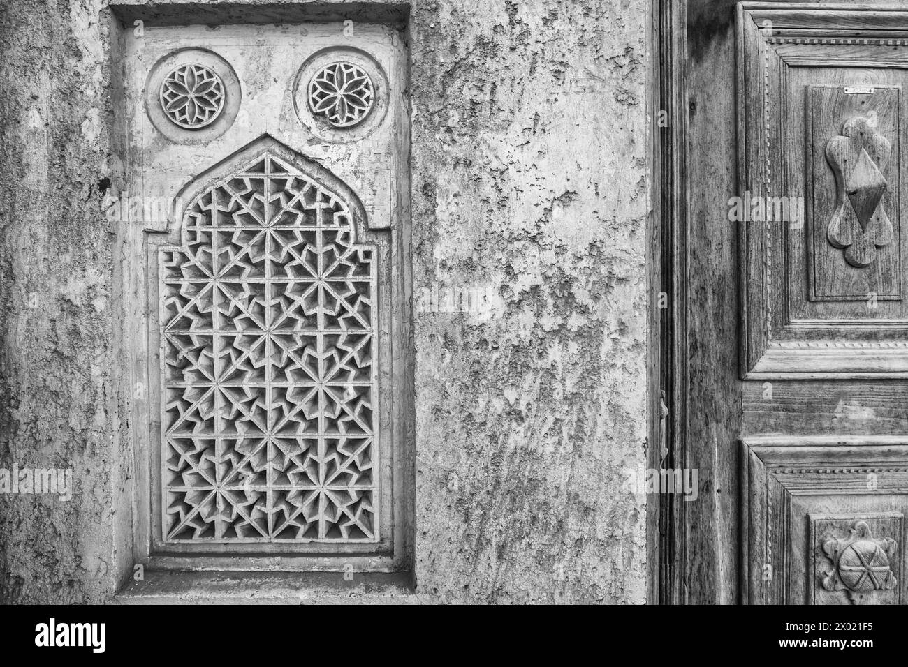 Monochrome, filtered image of a gypsum plaster ventilation lattice next ...